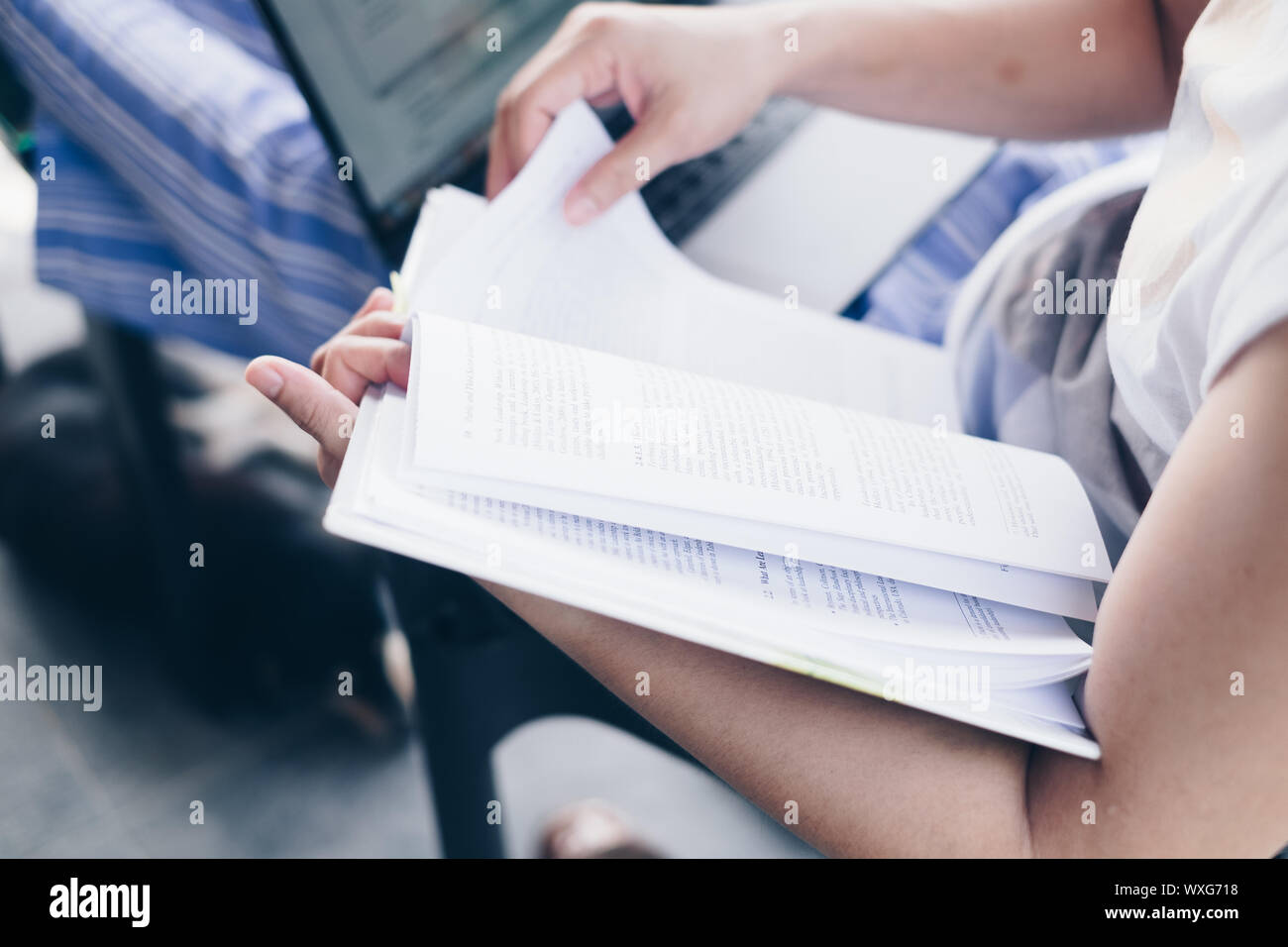Reading with a book on her lap hi-res stock photography and images - Alamy