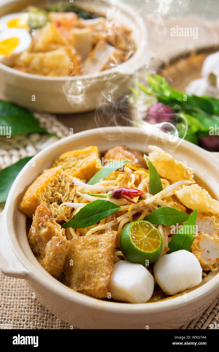 Hot and spicy Malaysian Curry Noodles or laksa mee with hot steam in ...
