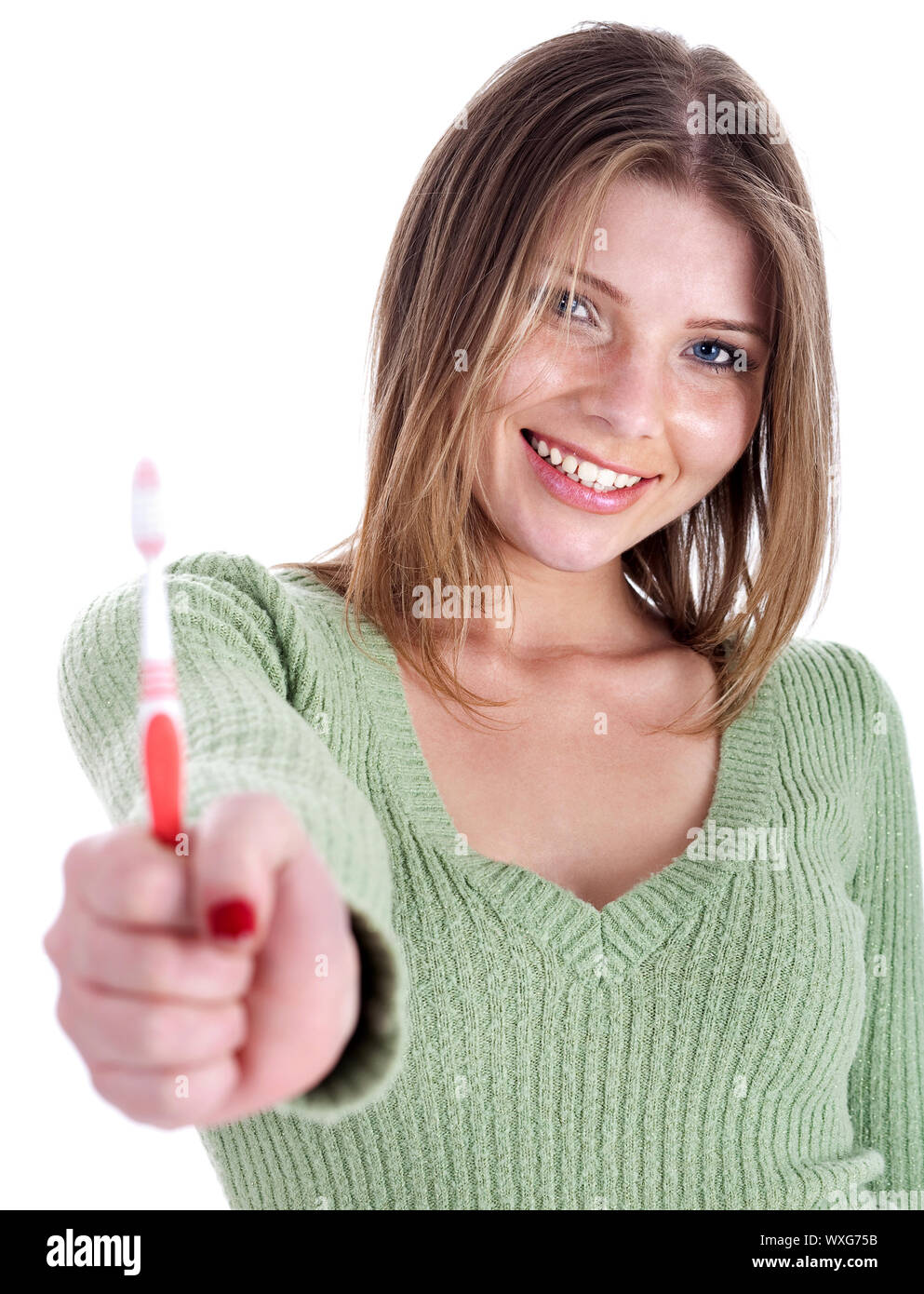 Beautiful woman holding tooth brush and smiling over white background ...