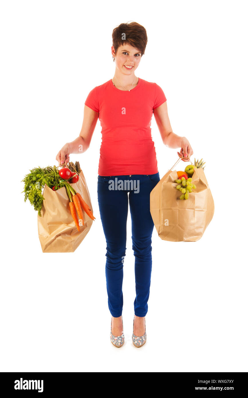 Pretty young woman with heavy bags healthy vegetables and fruit ...