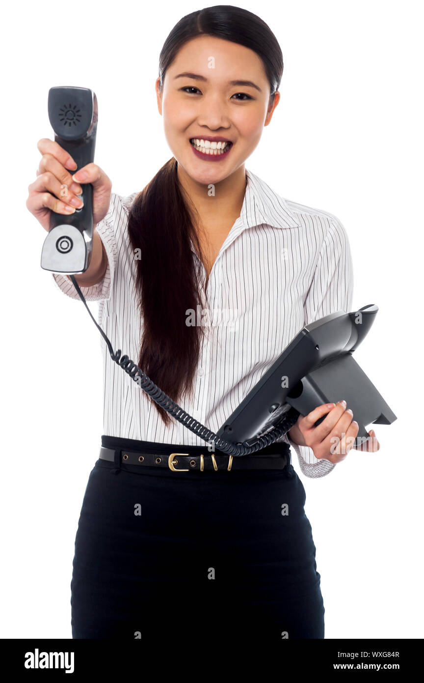 Smiling assistant handing over the telephone receiver to boss Stock ...