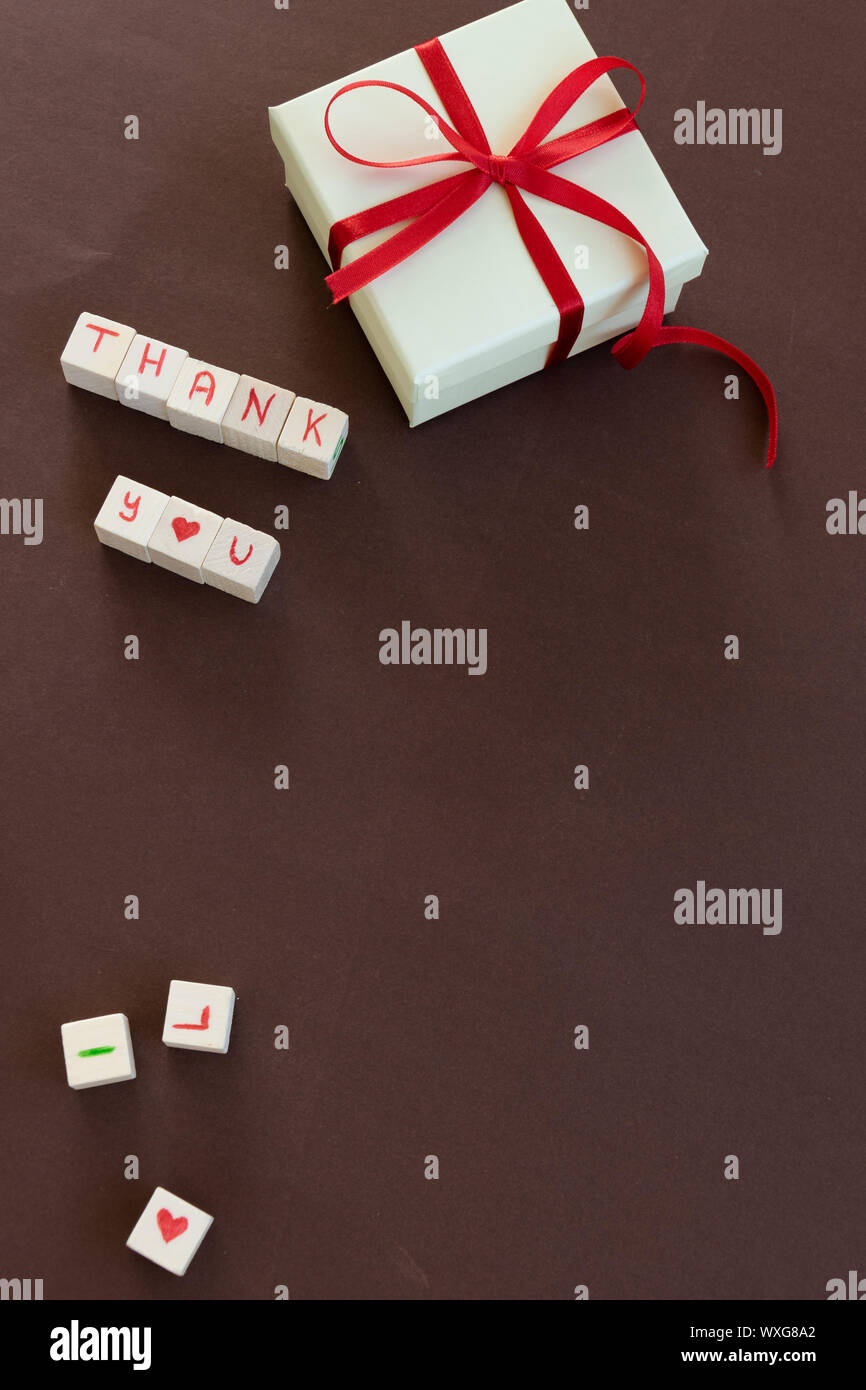 Isolated gift box with "Thank you" text on brown background Stock Photo ...