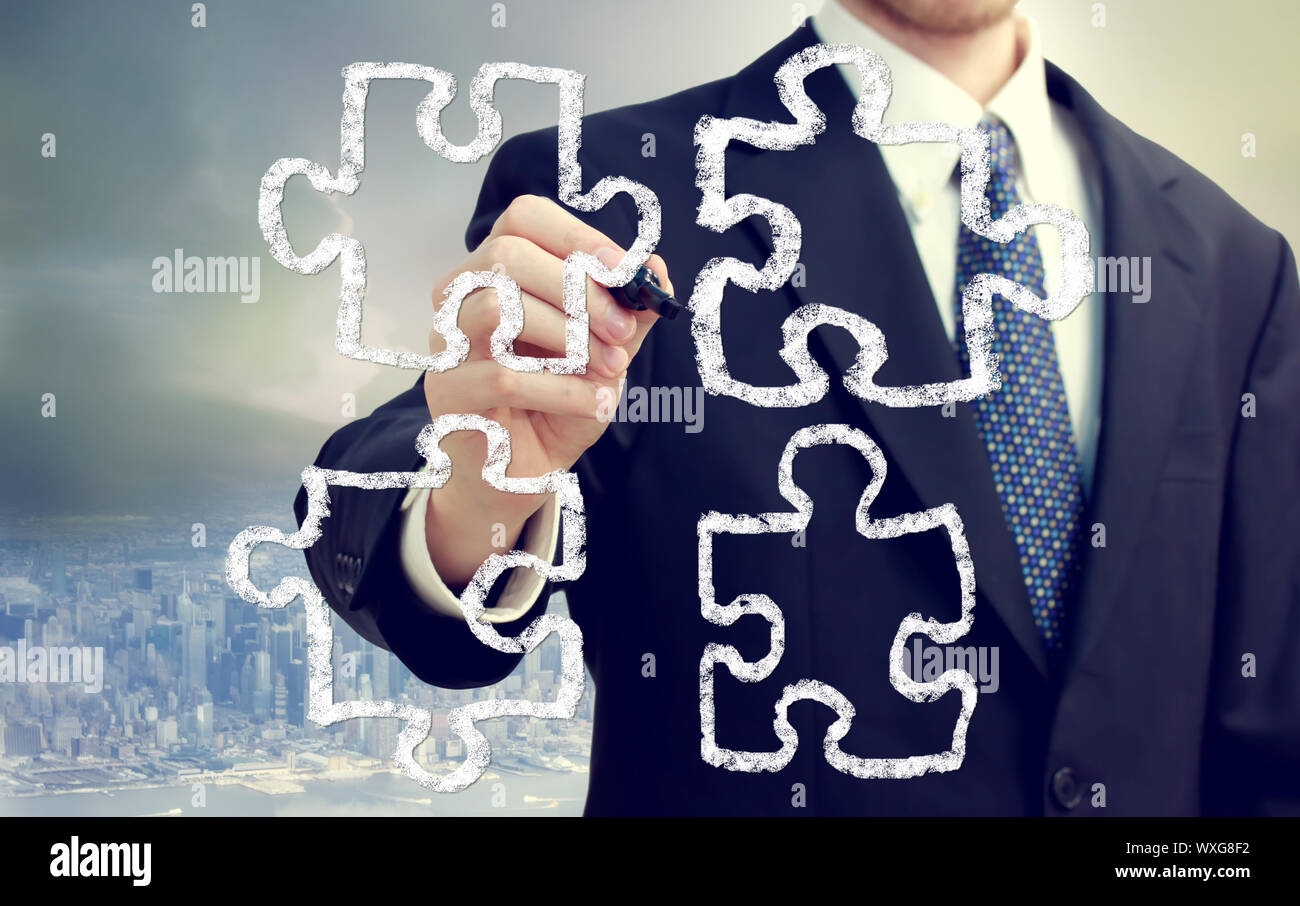 Businessman with puzzle pieces - concepts of strategy, creativity, and ...