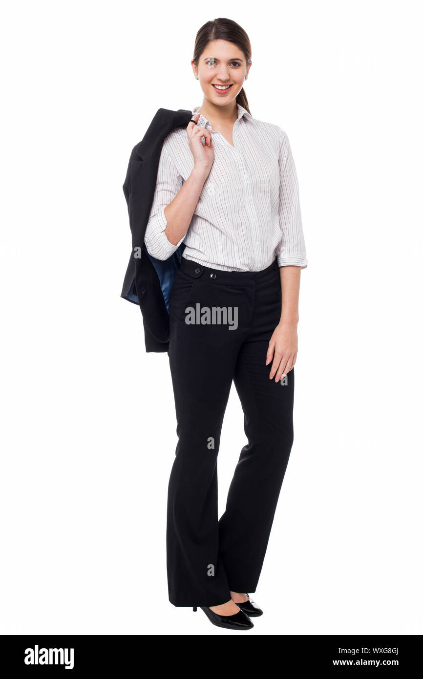 Pretty young woman with a blazer slung over her shoulder, full length ...