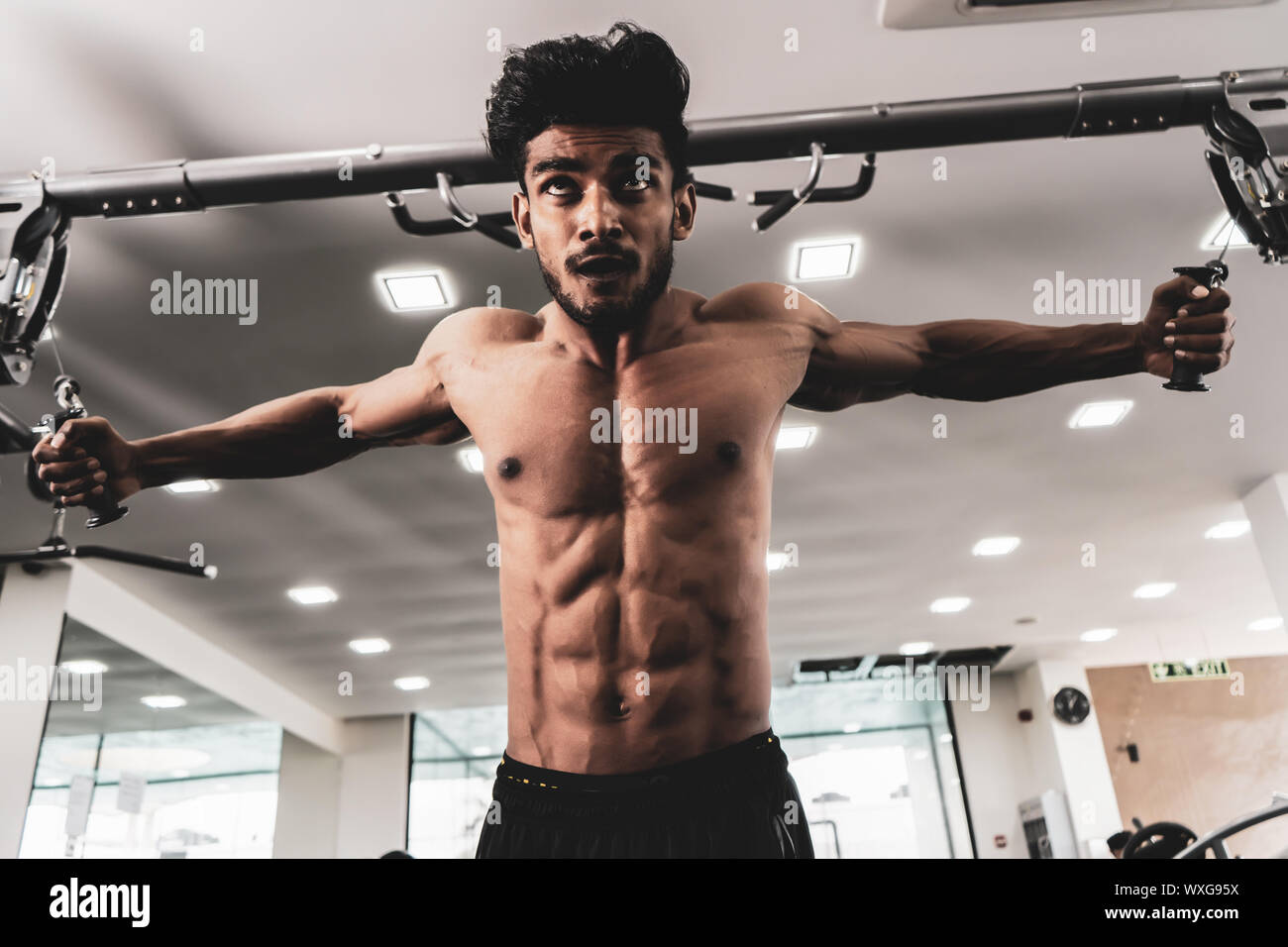 Bodybuilder Is Working On His Chest With Cable Crossover In Gym. Scream ...