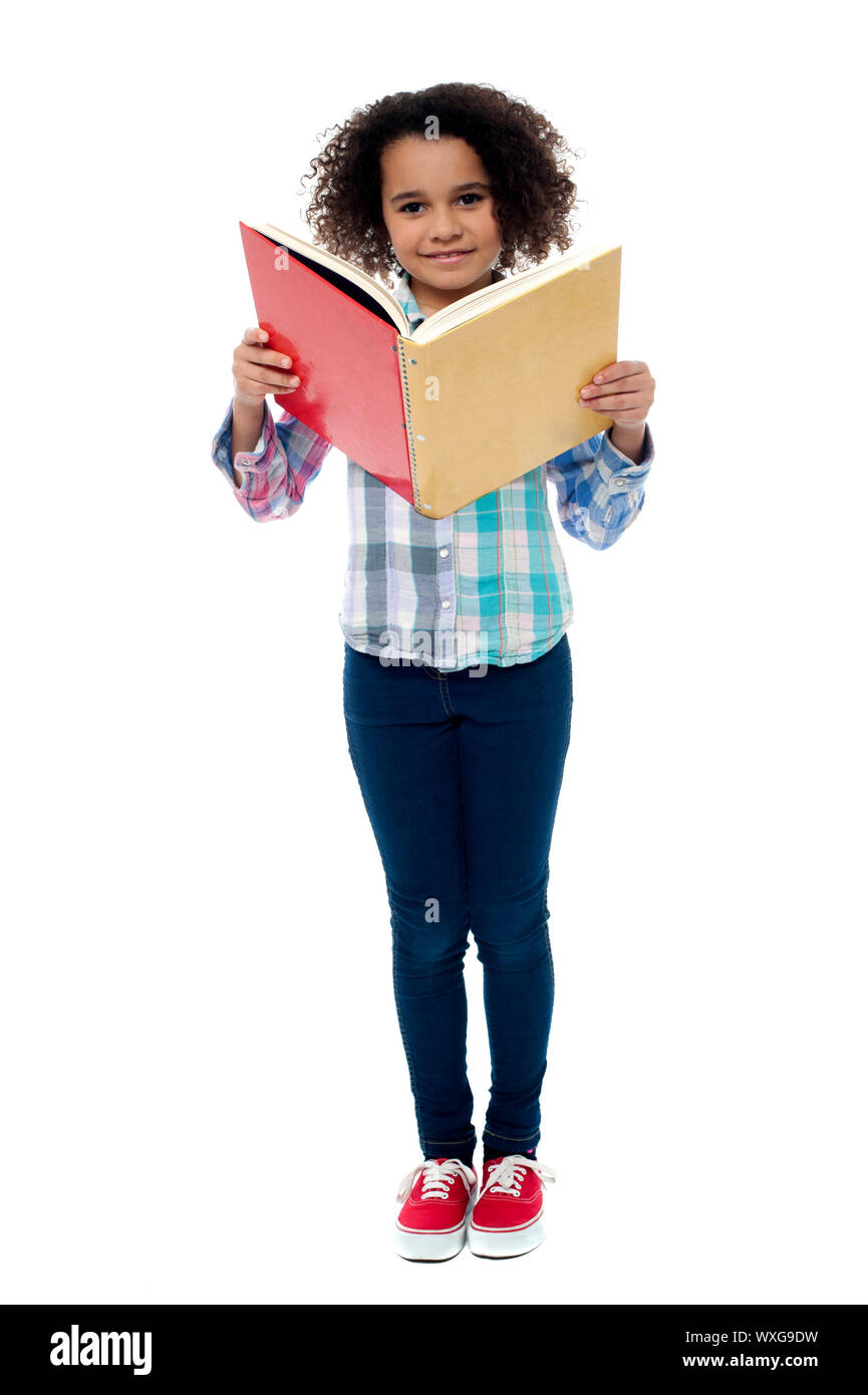 Small school girl reading a book on white Stock Photo - Alamy