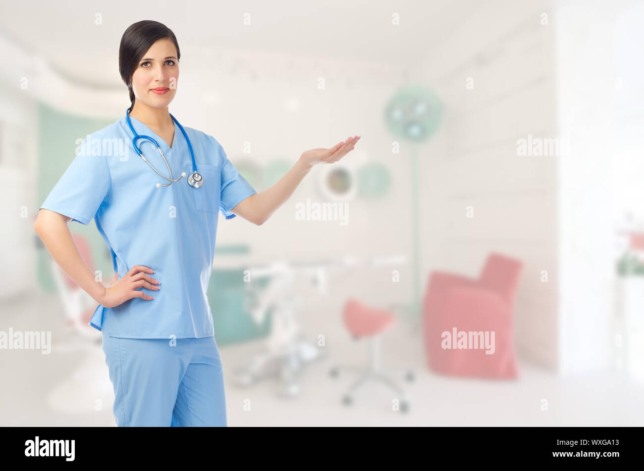 Young doctor shows welcome gesture at medical office Stock Photo - Alamy