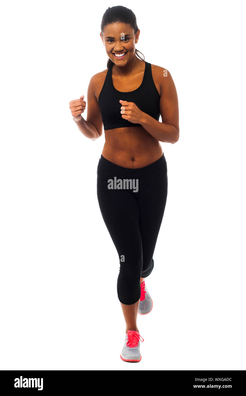 Pretty woman in fitness wear jogging towards the camera Stock Photo - Alamy