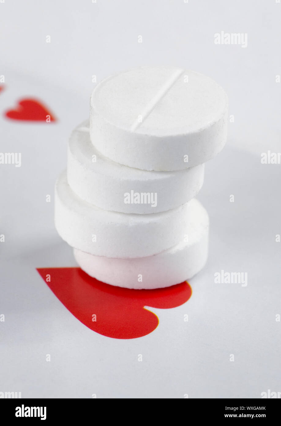 Roll of tablets and heart on the playing card background Stock Photo ...