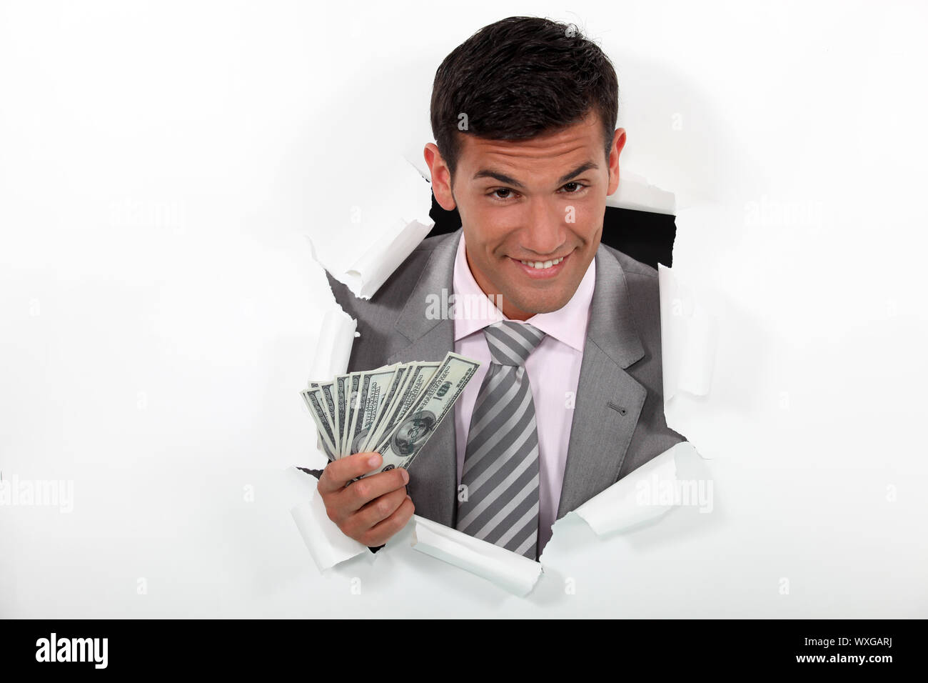 Happy businessman holding wedge of bank notes Stock Photo - Alamy