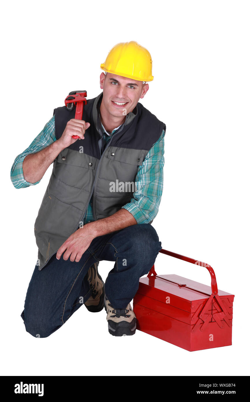Smiling plumber with his toolbox on white background Stock Photo - Alamy
