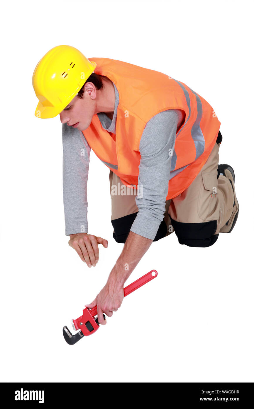 Tradesman using a pipe wrench Stock Photo - Alamy