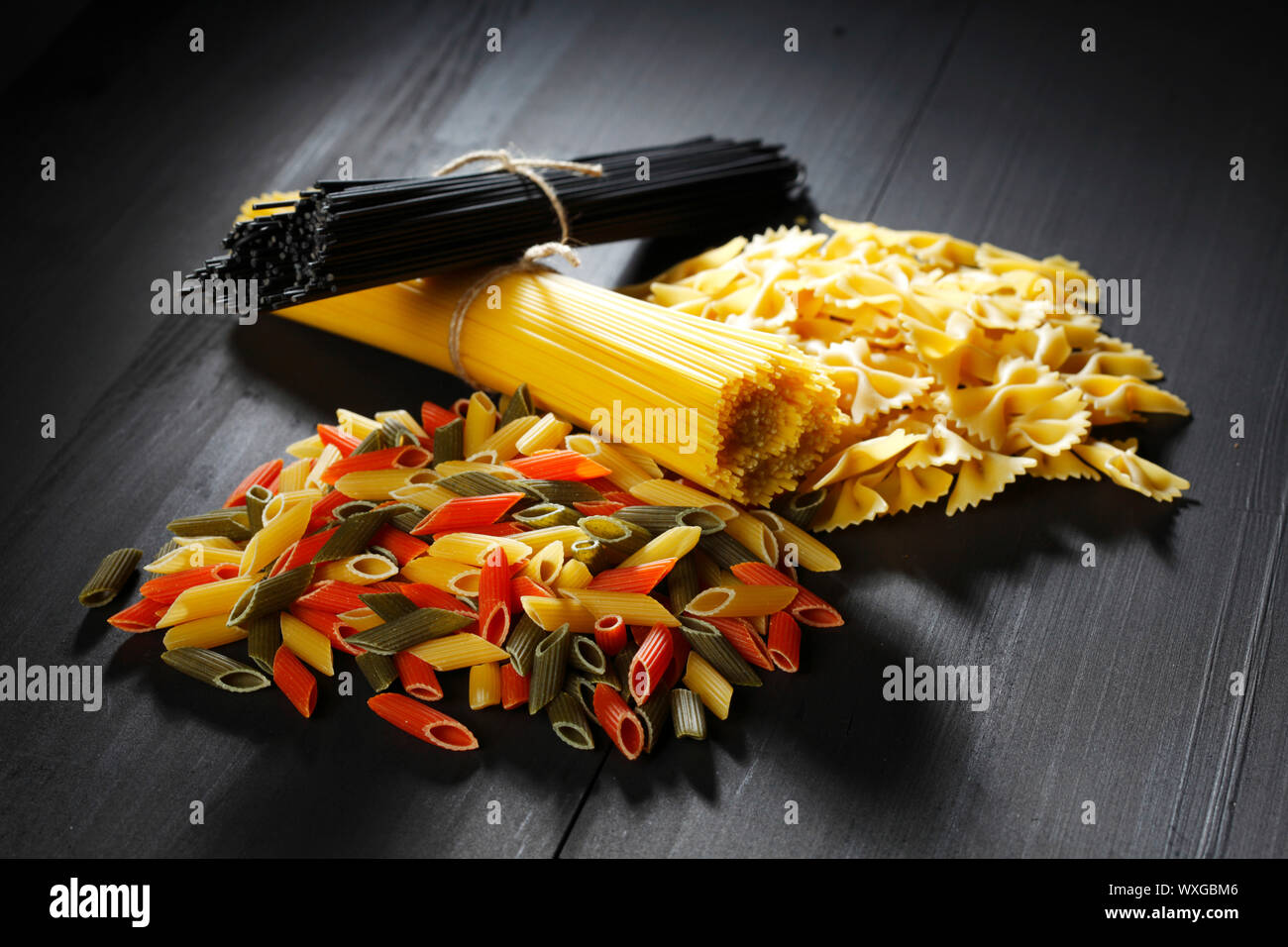 Variety of types and shapes of Italian pasta on black table Stock Photo ...