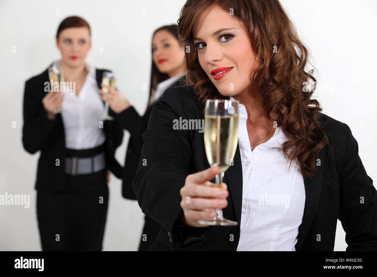 Three young business women toasting success Stock Photo - Alamy