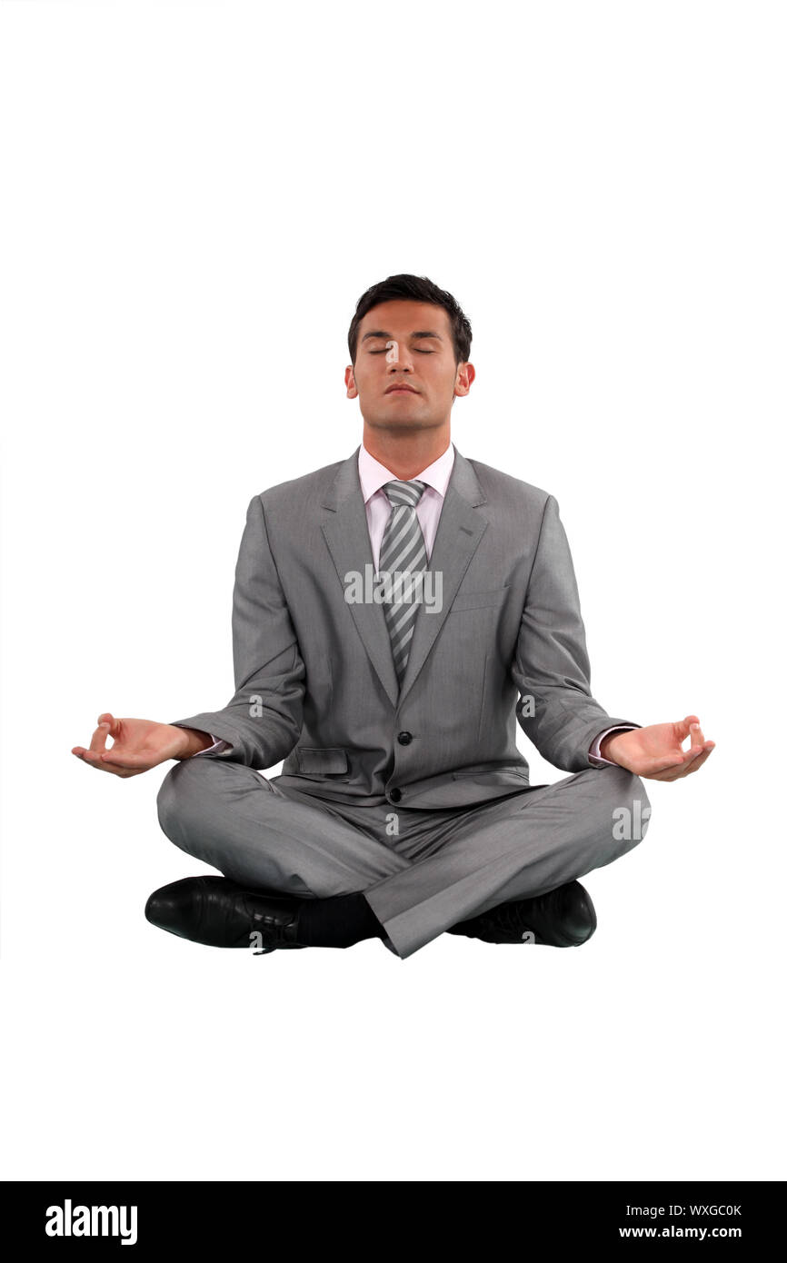 Businessman sat in lotus position Stock Photo - Alamy