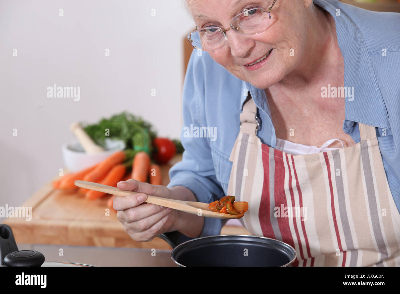 senior woman cooking Stock Photo - Alamy