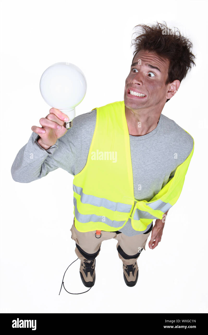 Shocked man holding light-bulb Stock Photo - Alamy