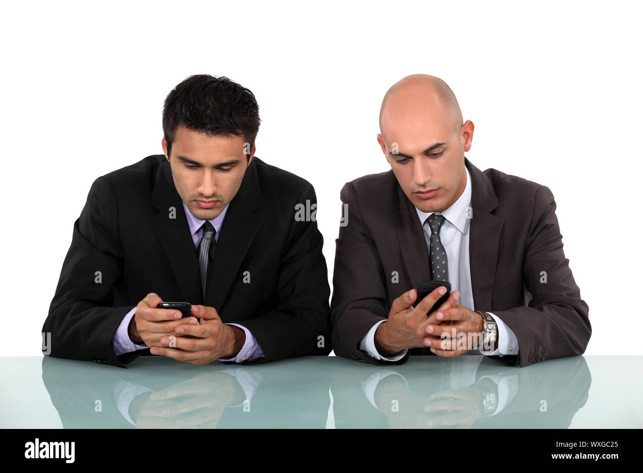 Two businessmen sending text messages Stock Photo - Alamy