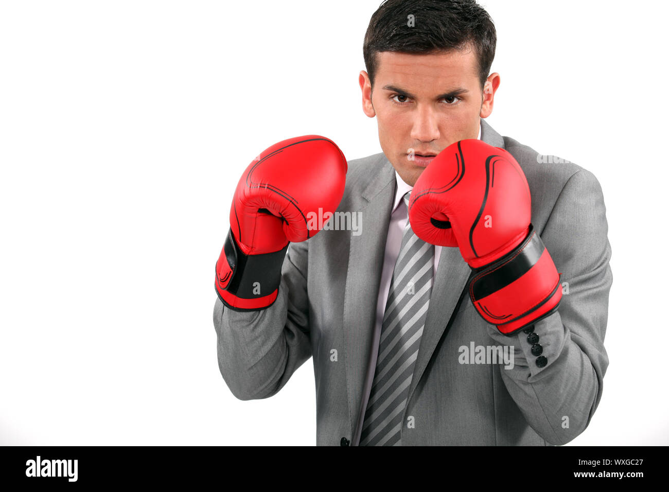 Businessman wearing boxing gloves Stock Photo - Alamy