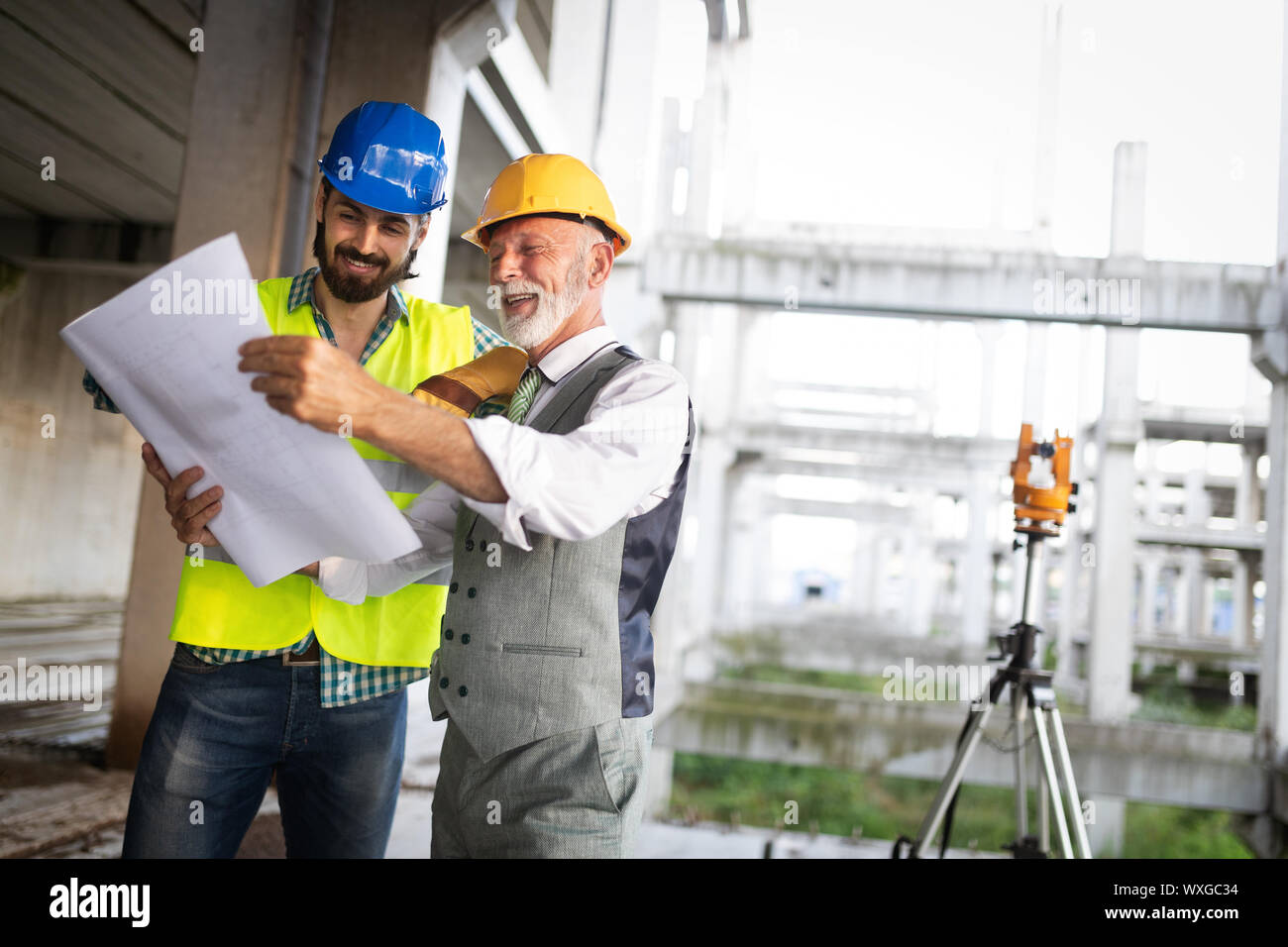 Construction engineers discussion with architects at construction or ...