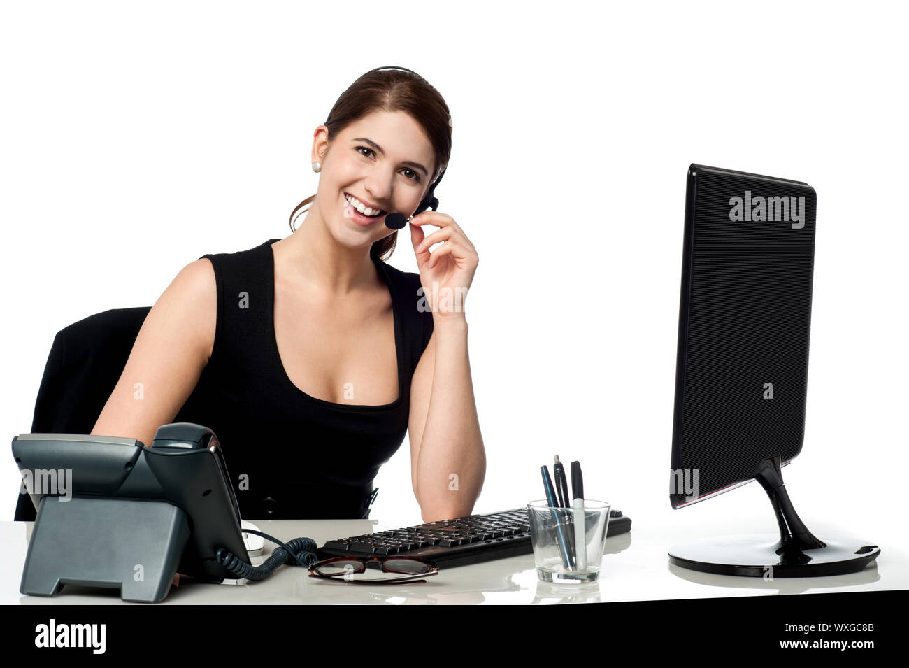 Young pretty female support staff attending clients queries Stock Photo ...