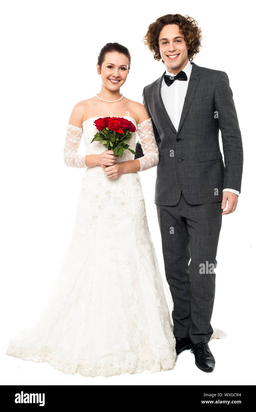 Happy young bride and groom, white background Stock Photo - Alamy