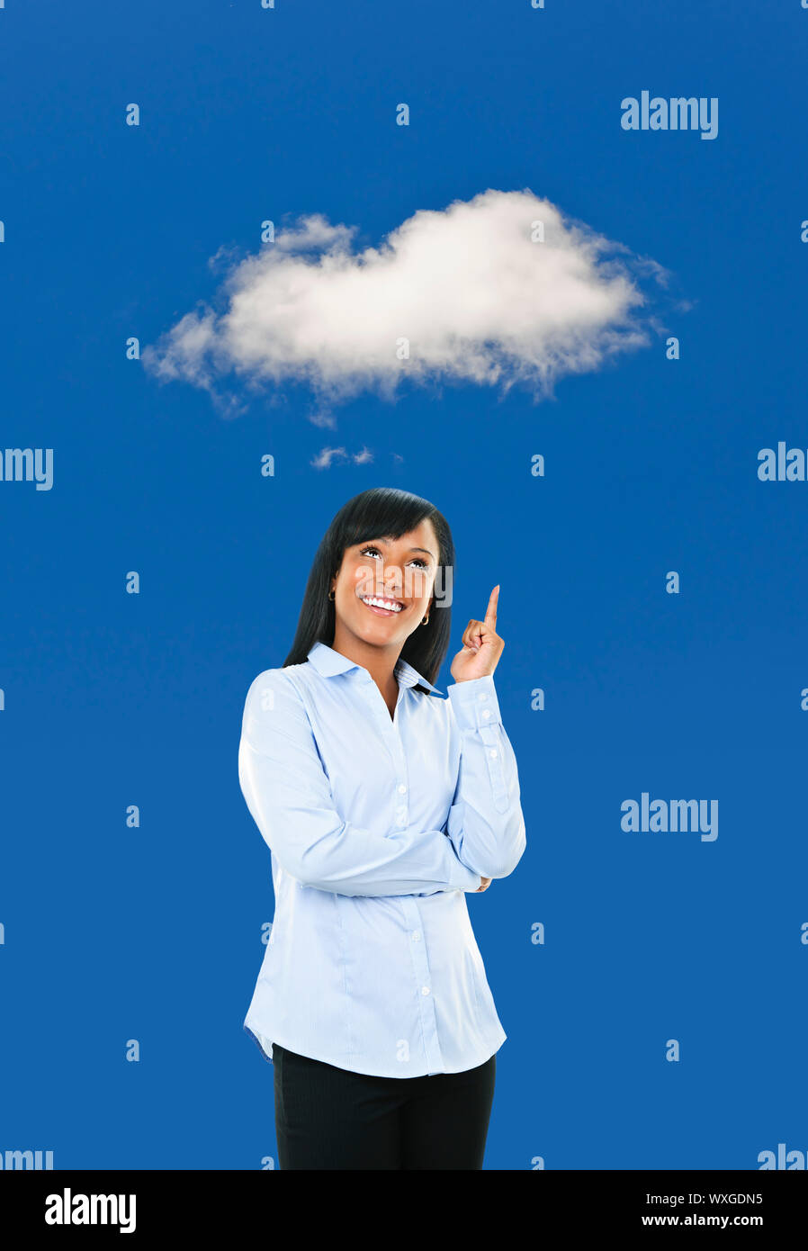 Smiling black woman thinking about cloud computing Stock Photo - Alamy