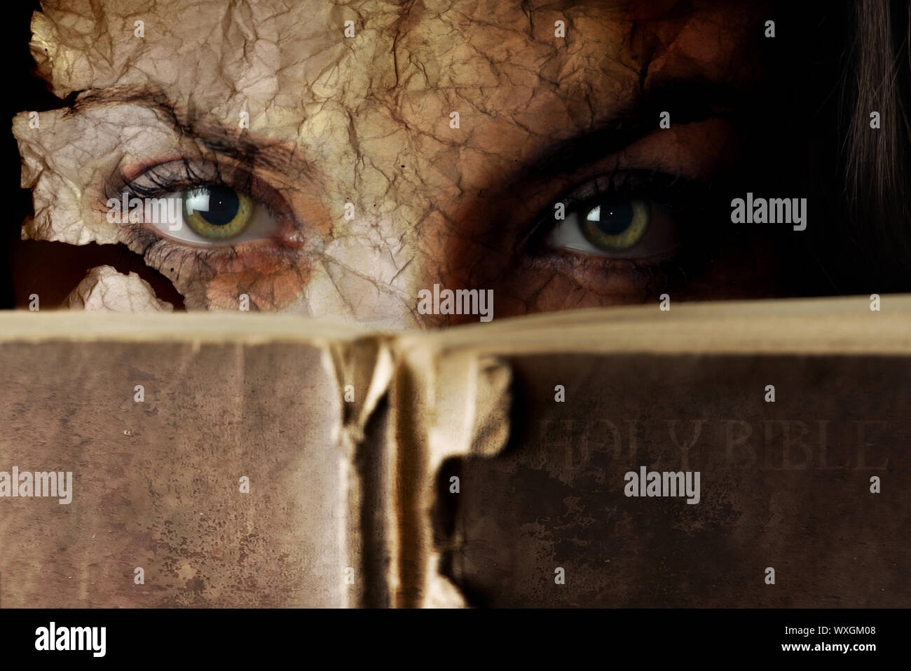 Conceptual photo of old Bible and cracked face Stock Photo - Alamy