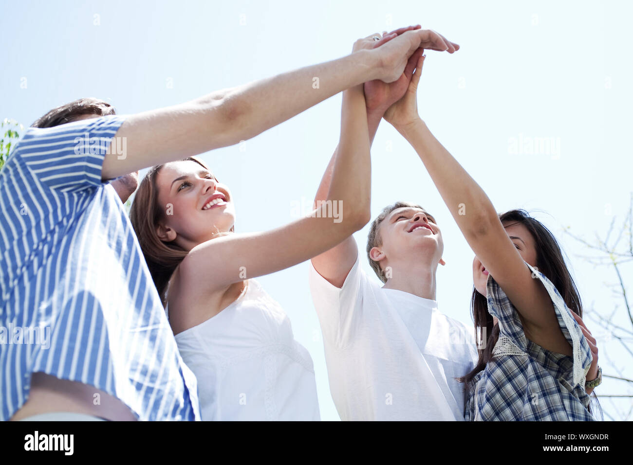 Hands of young men and women showing unity Stock Photo - Alamy