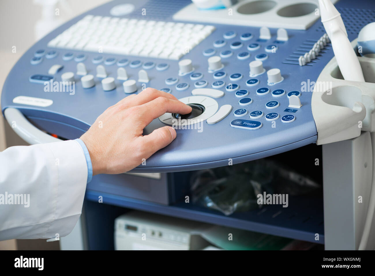 Sonographer using ultrasound machine at work. Modern medical device for ...