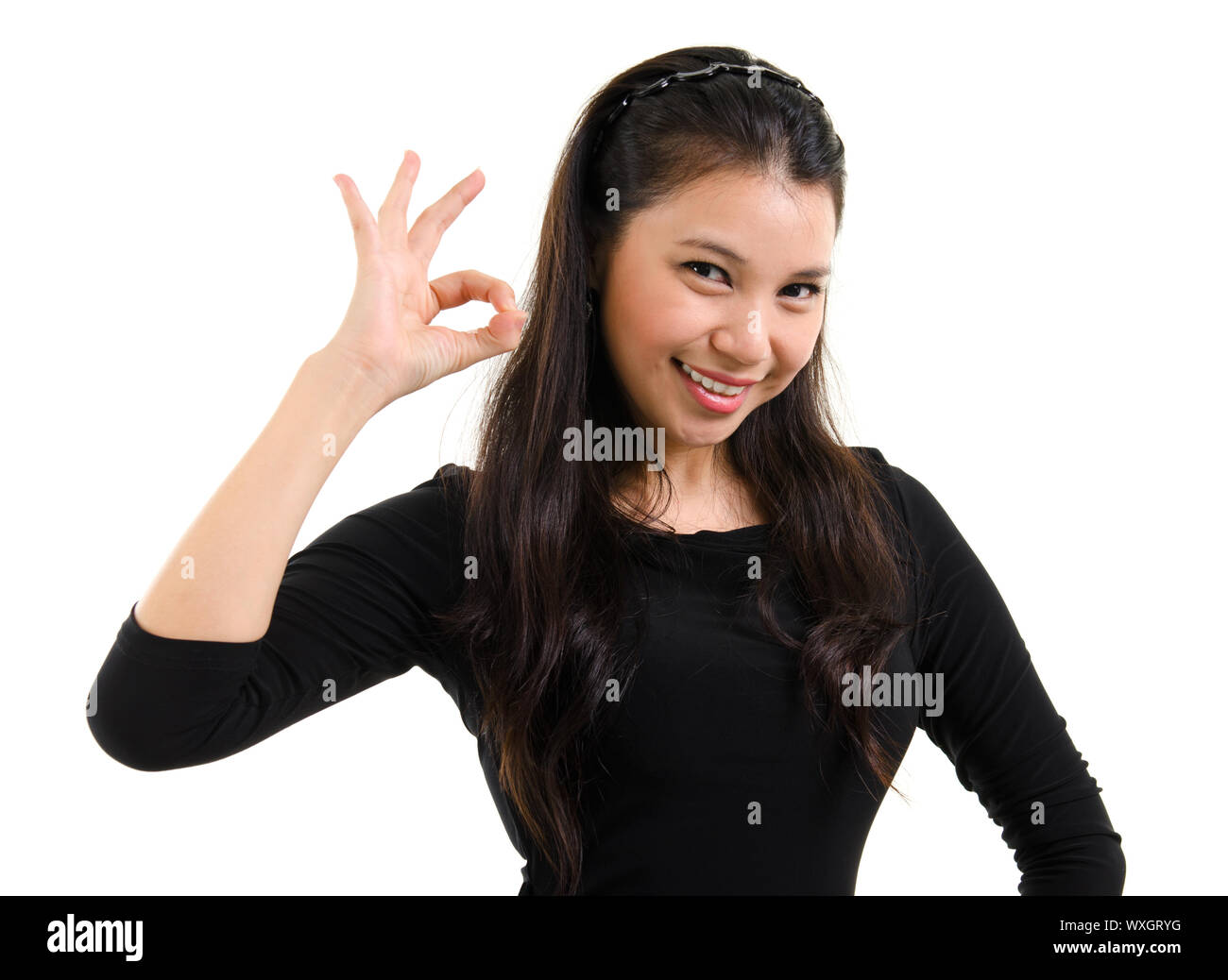 Pretty young woman showing okay hand sign with great smile standing ...