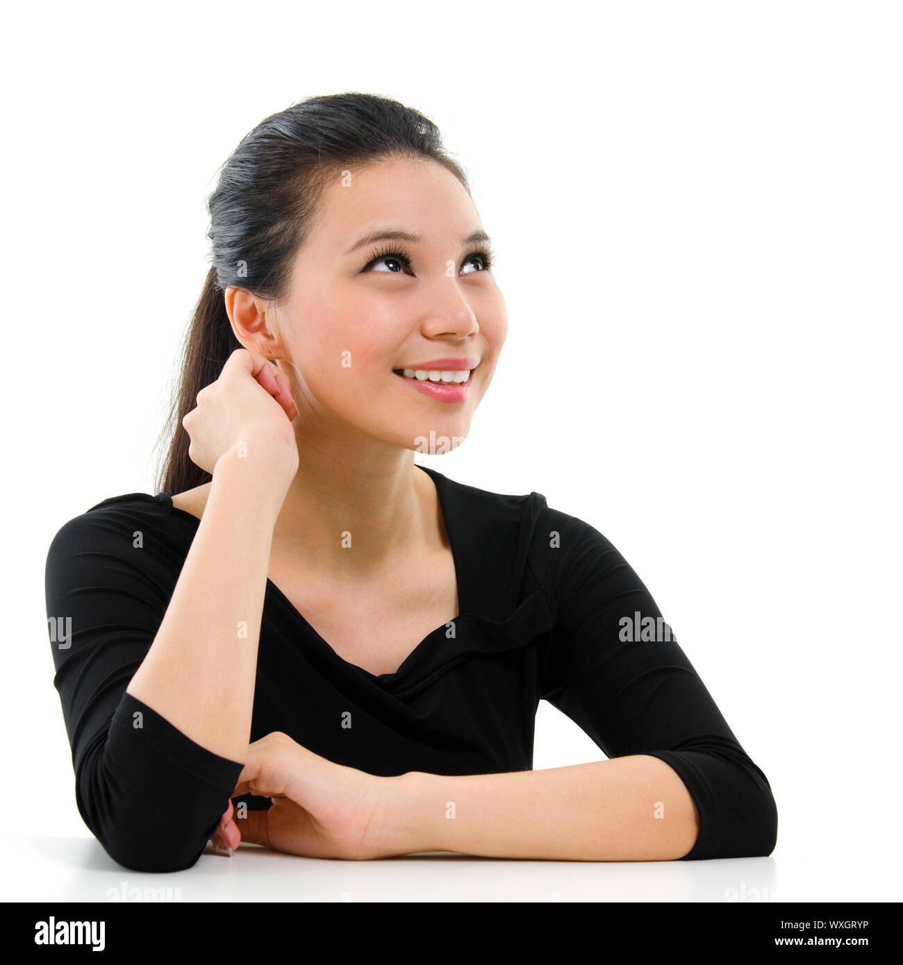 Asian woman portrait. Young gorgeous female looking up at blank space ...