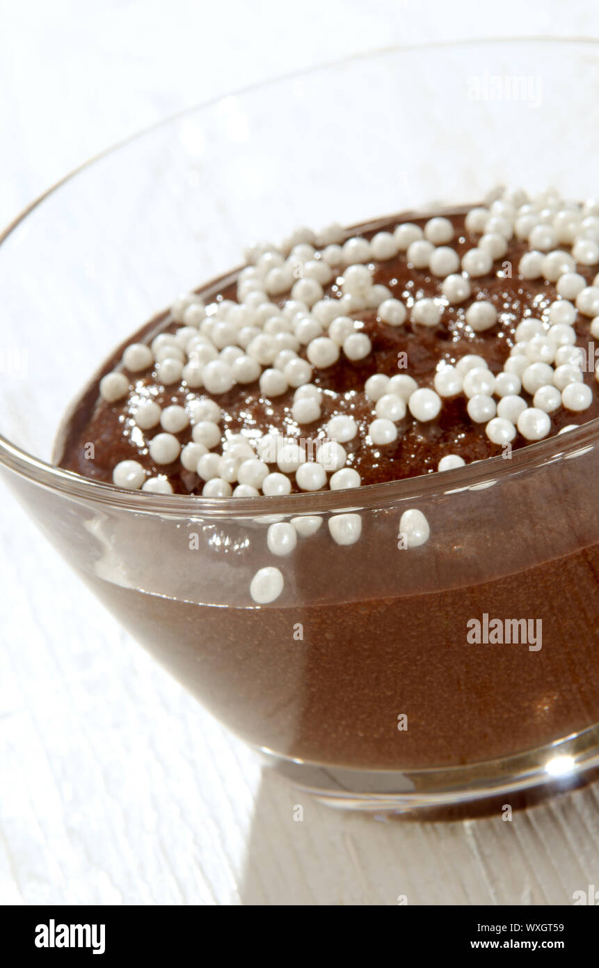 chocolate pudding with white sugar balls in a glass bowl Stock Photo ...
