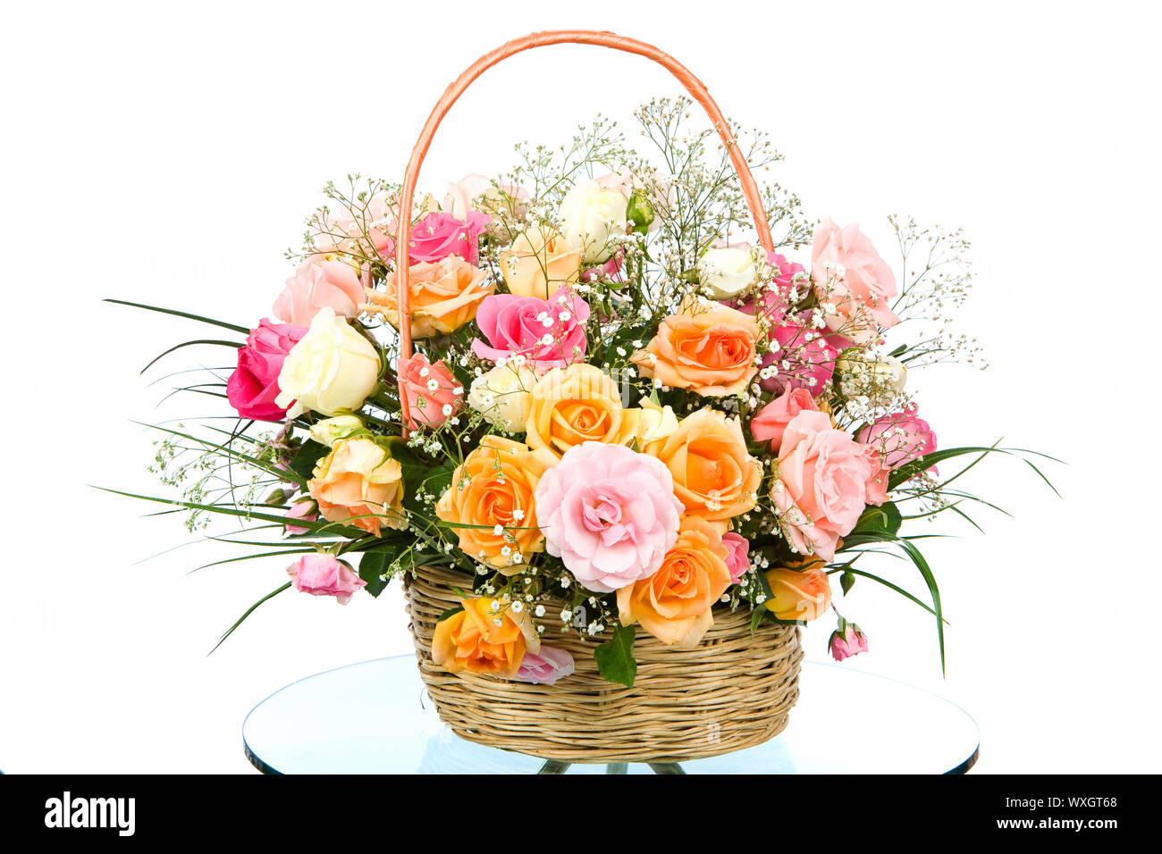 Basket with colored roses on white background Stock Photo - Alamy