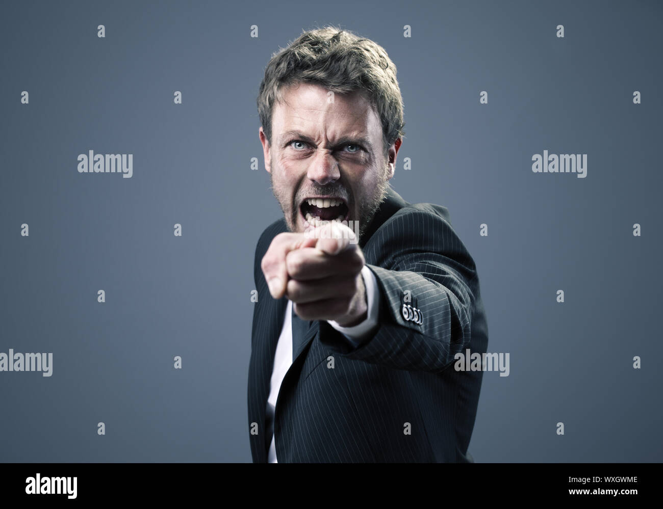 An angry businessman points at the camera Stock Photo - Alamy