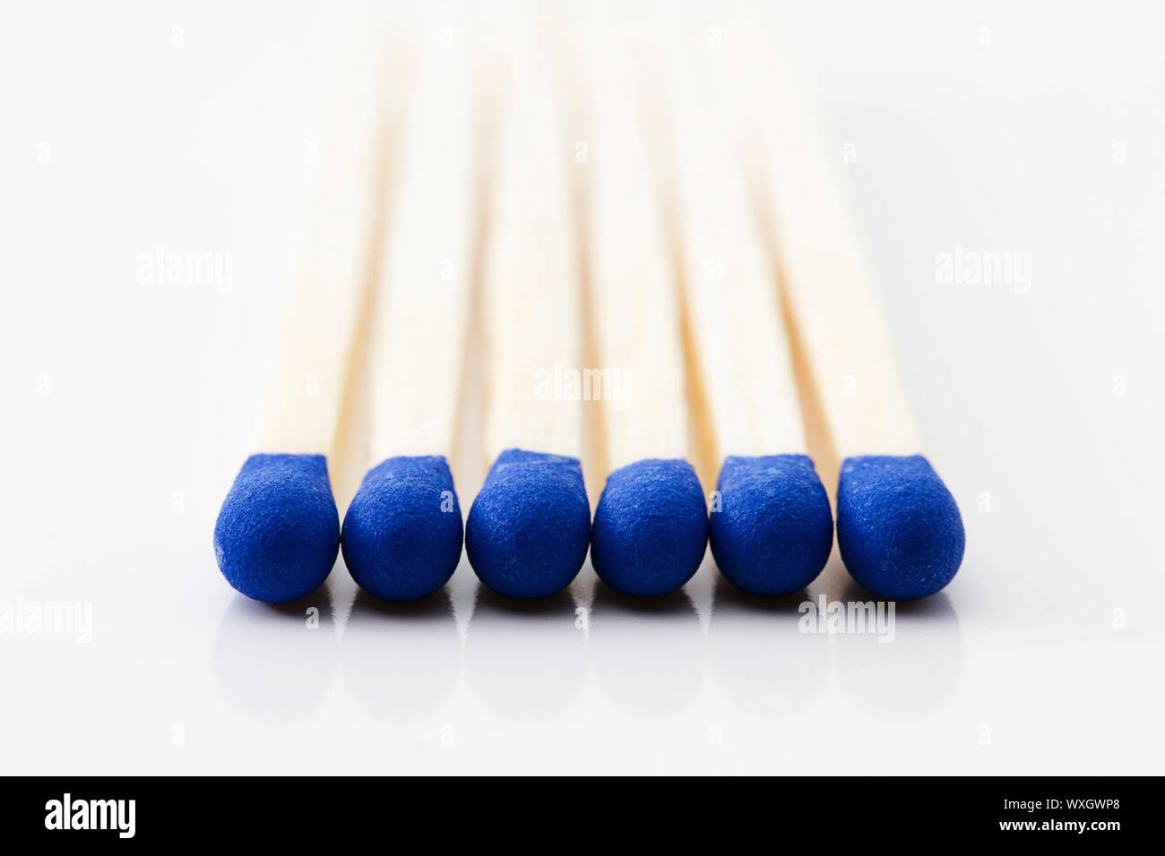 makro of some blue match heads on white background Stock Photo - Alamy