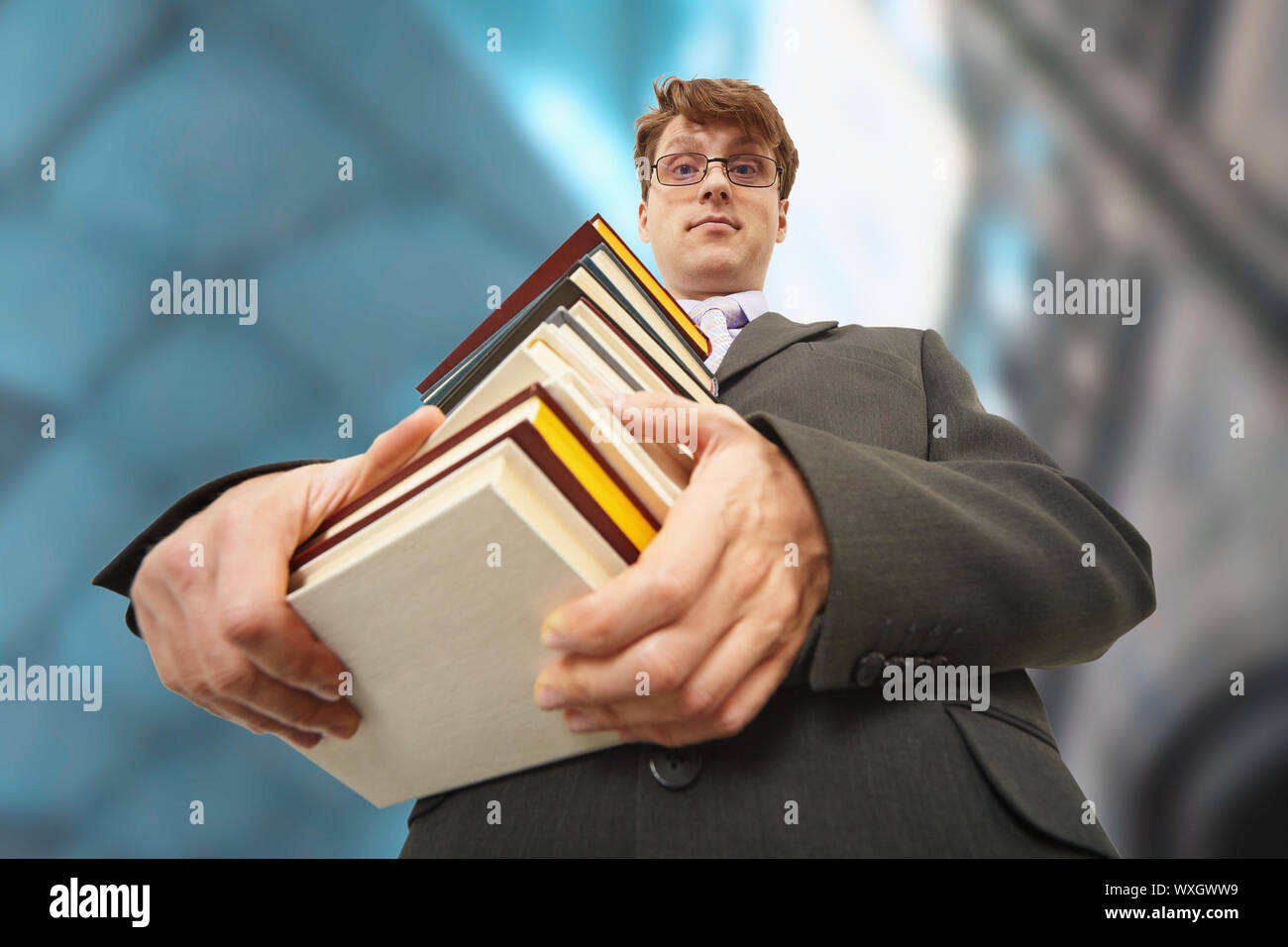 A librarian holding a big pile of books Stock Photo - Alamy