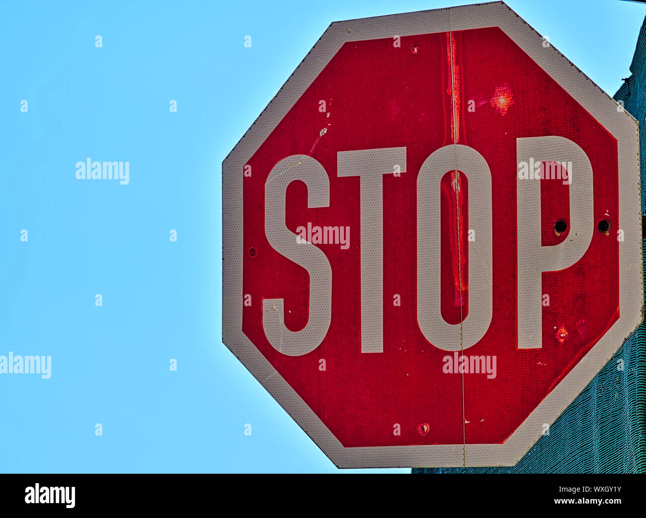Vivid road stop sign against blue sky background Stock Photo - Alamy