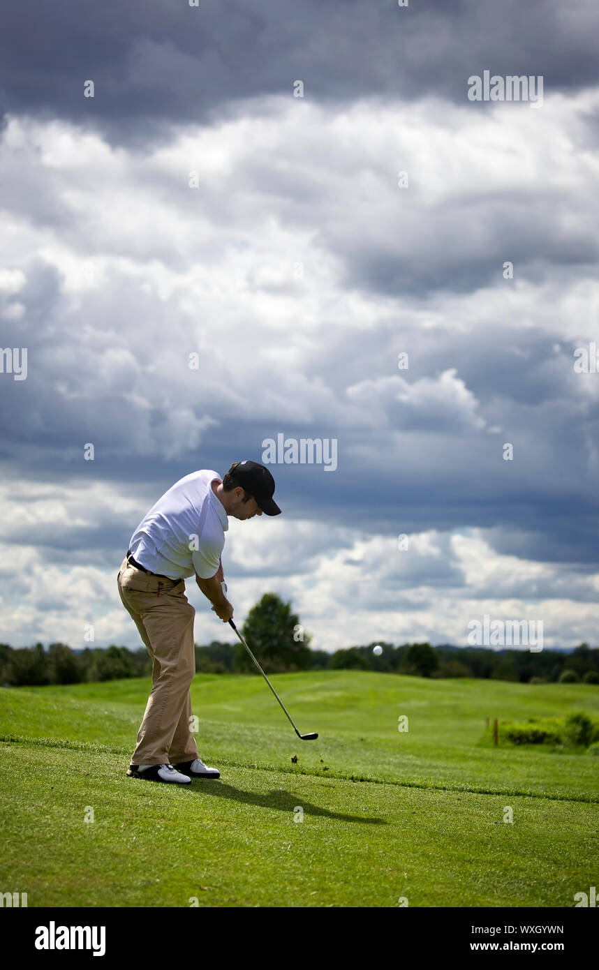 Golf player pitching Stock Photo - Alamy