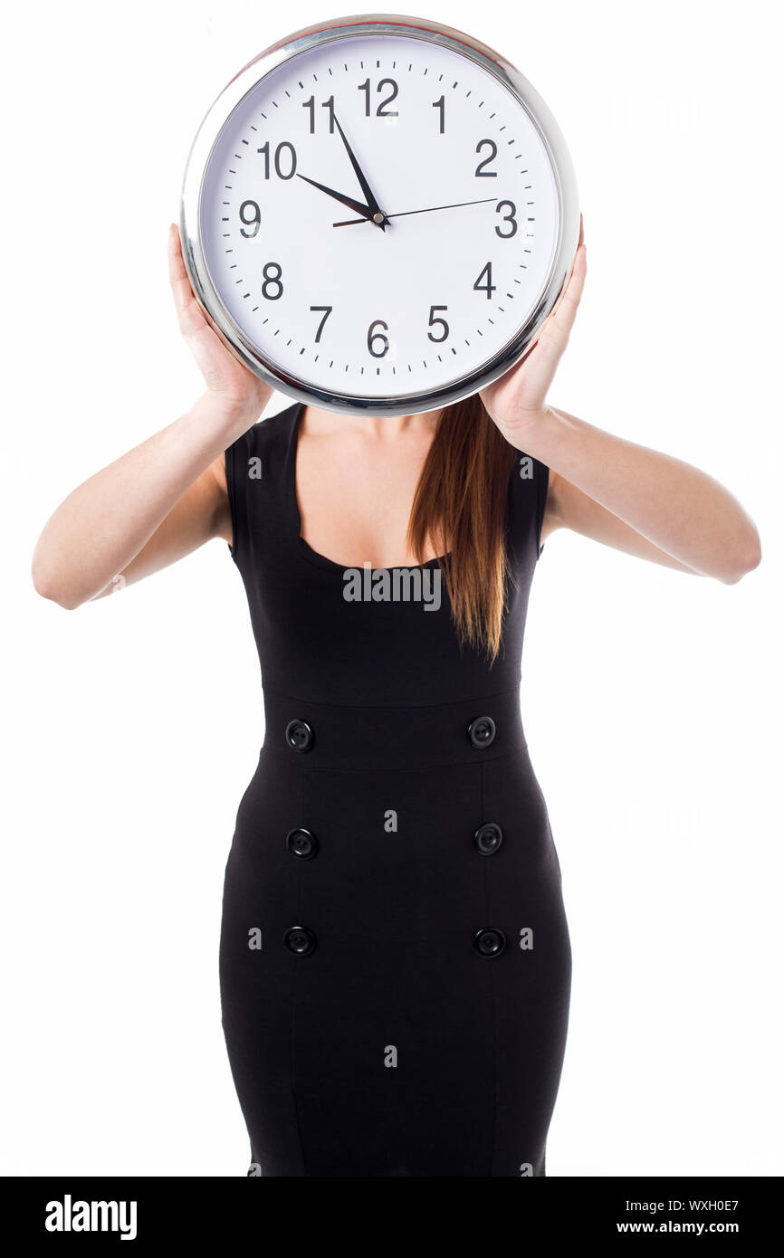 Young woman hiding her face with a wall clock Stock Photo - Alamy
