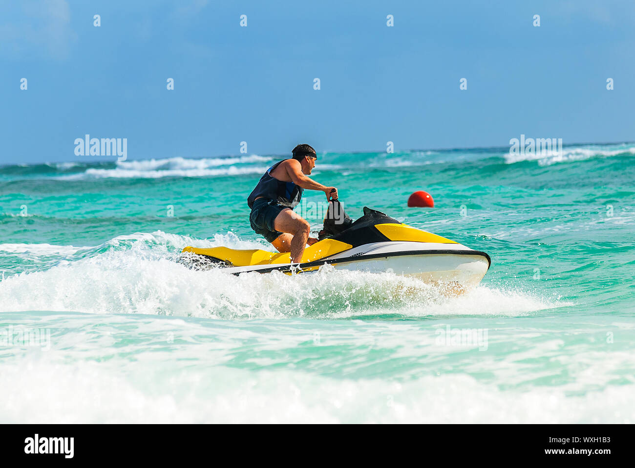 Man on Wave Runner turns fast on the water Stock Photo - Alamy