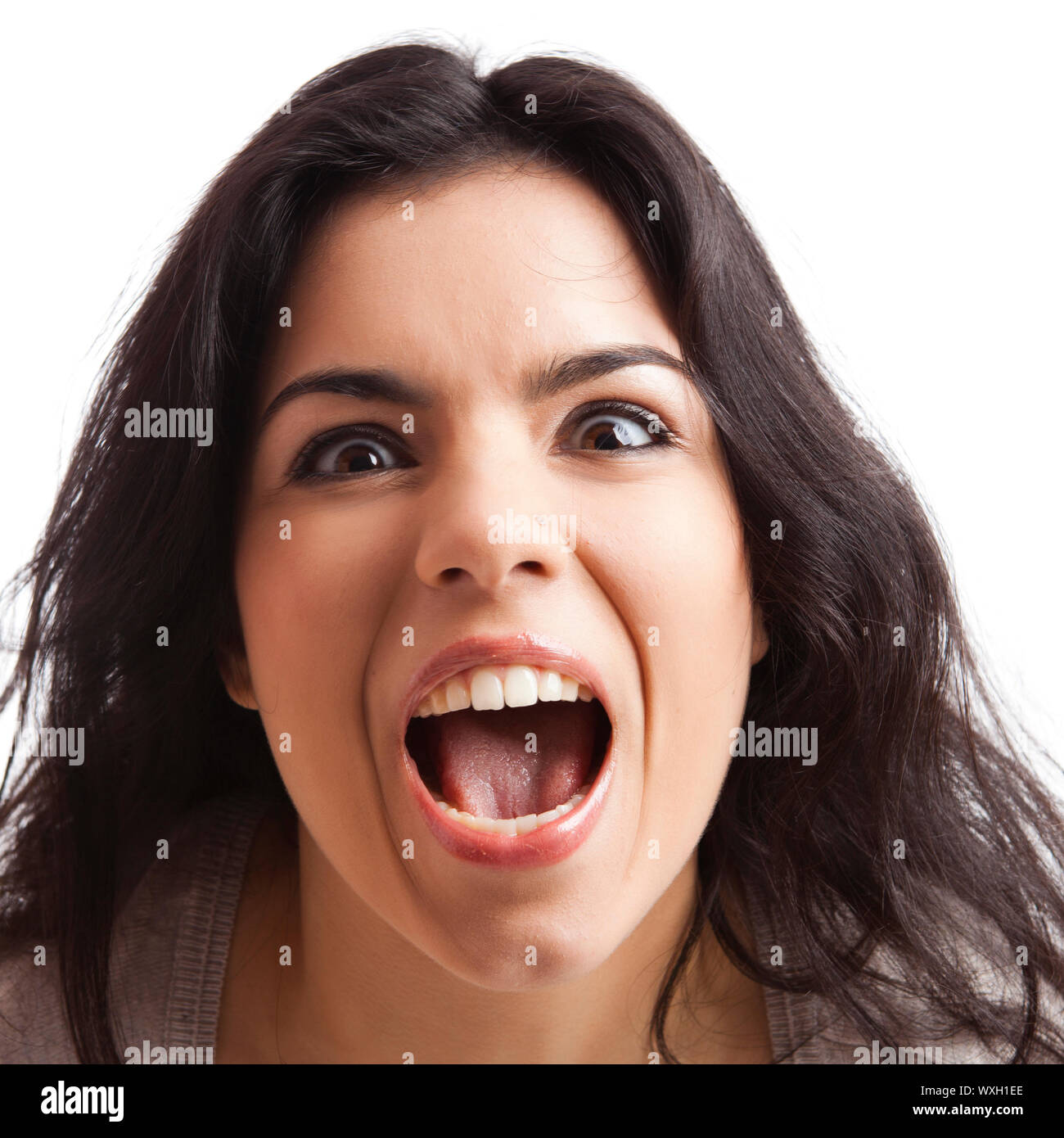 Portrait of a young woman with a crazy expresion, isolated over white ...