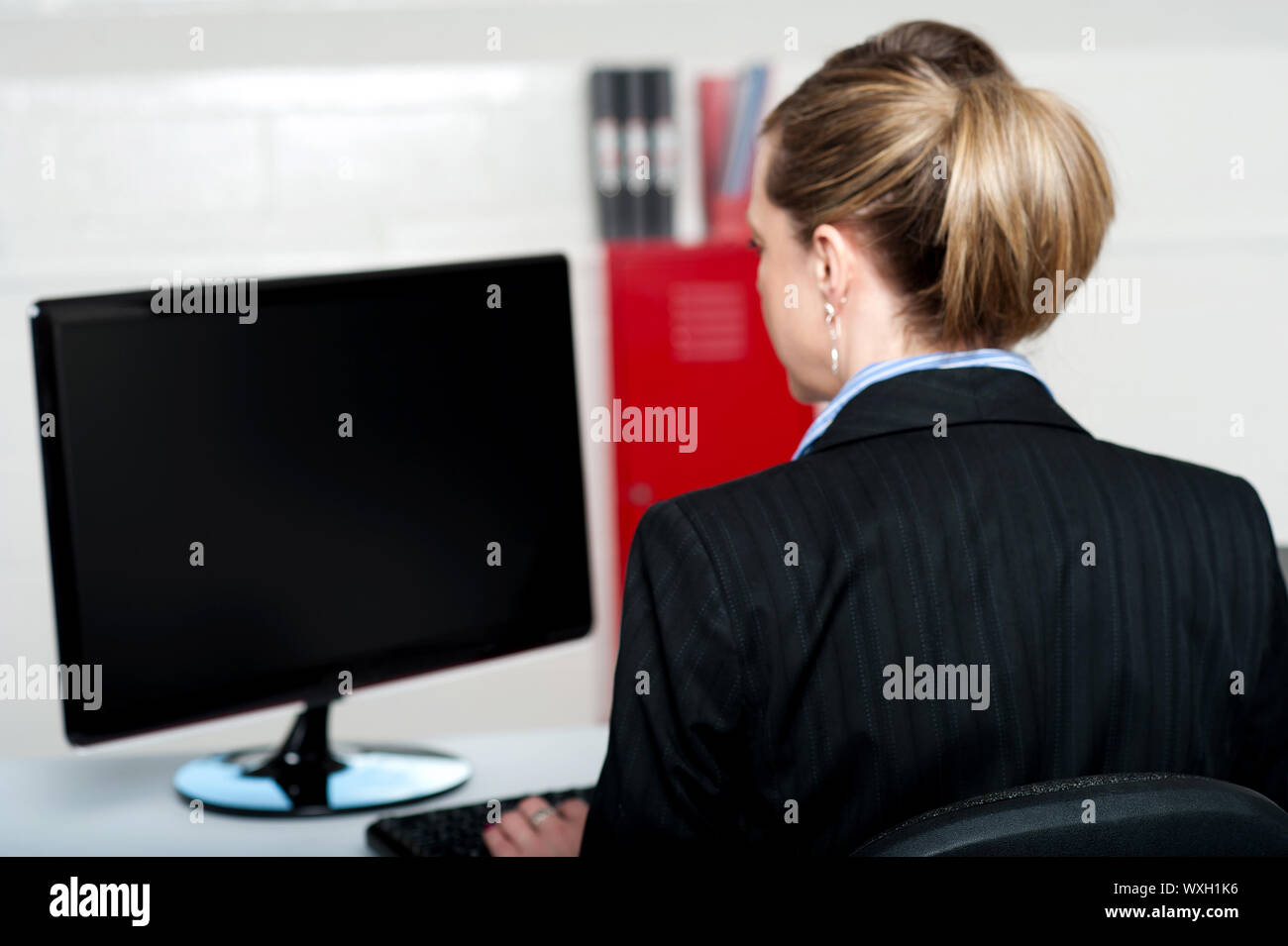 Business woman at her work desk, typing Stock Photo - Alamy