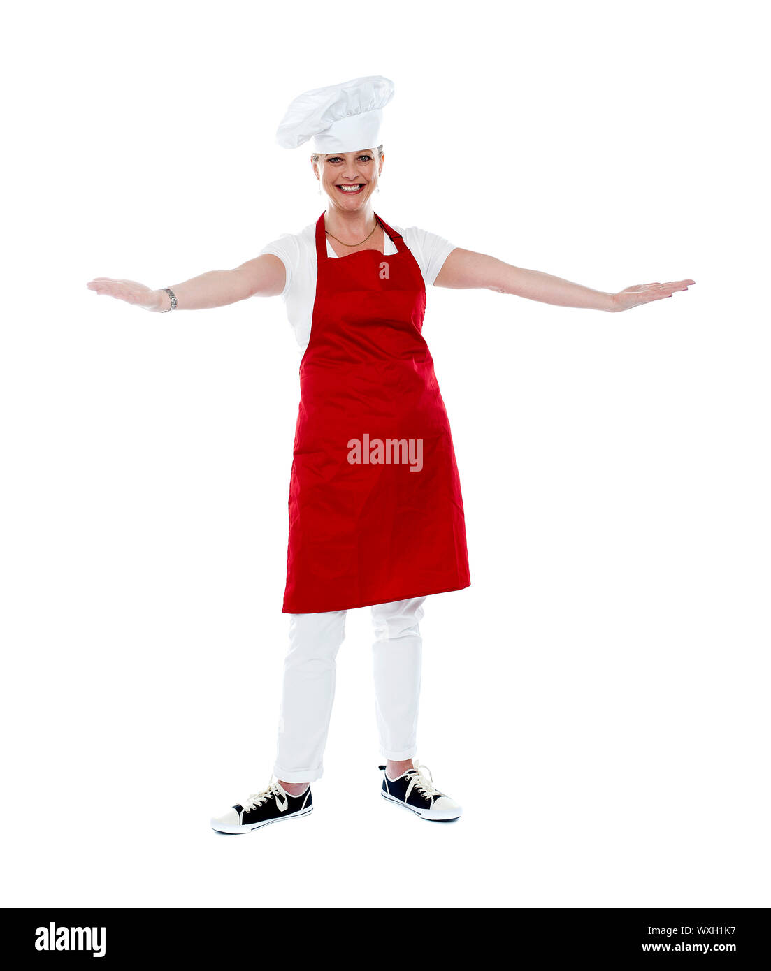 Portrait of a smiling female chef, arms outstretched Stock Photo - Alamy