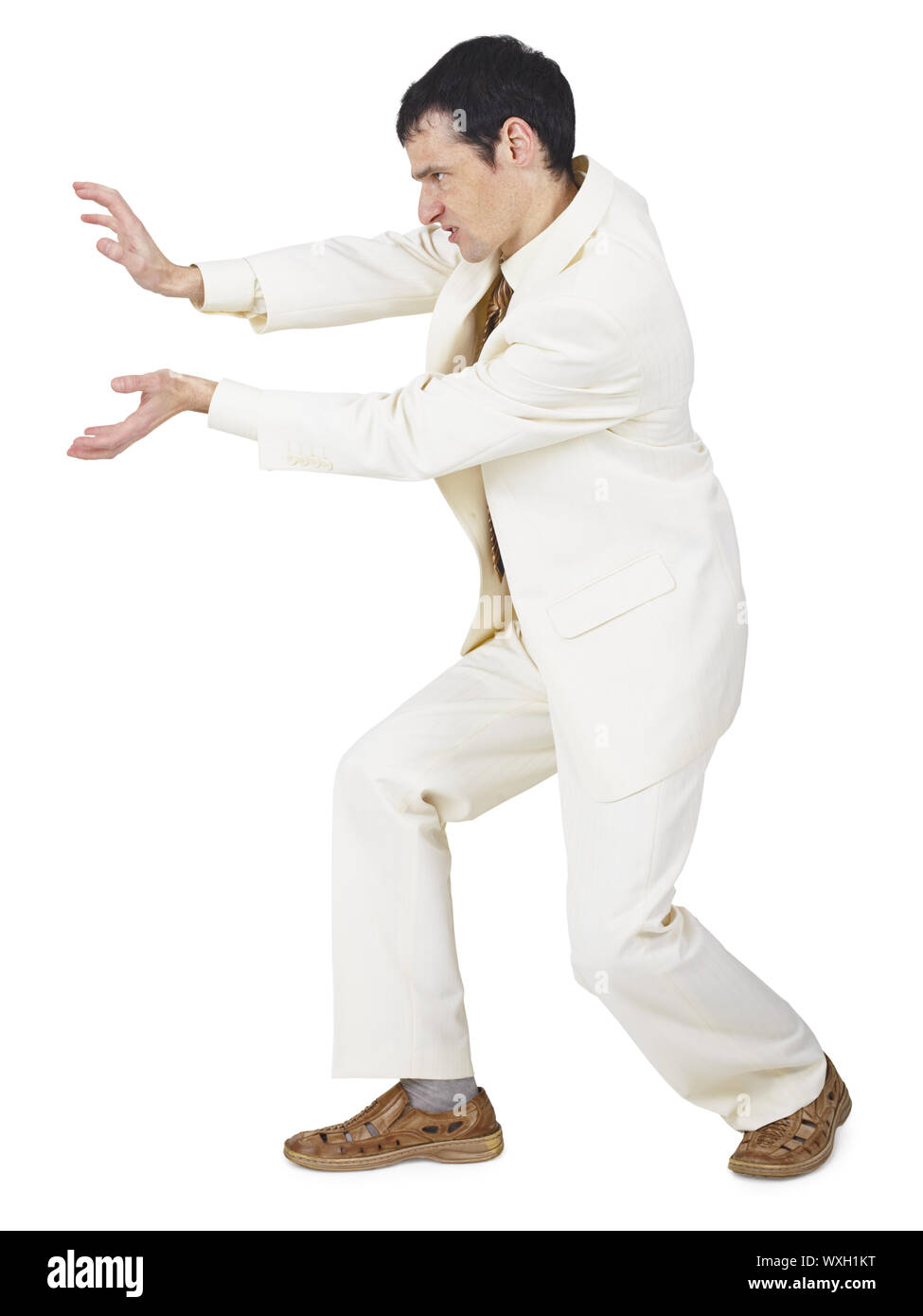 The amusing businessman pushes something forward on white Stock Photo ...