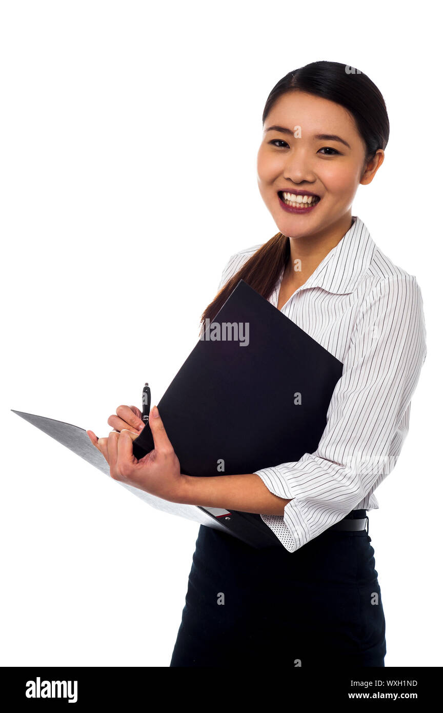 Young secretary cross-checking list of appointments Stock Photo - Alamy