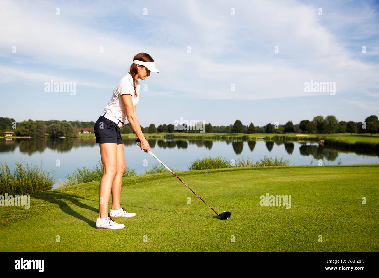 Golf player preparing for teeing off Stock Photo - Alamy