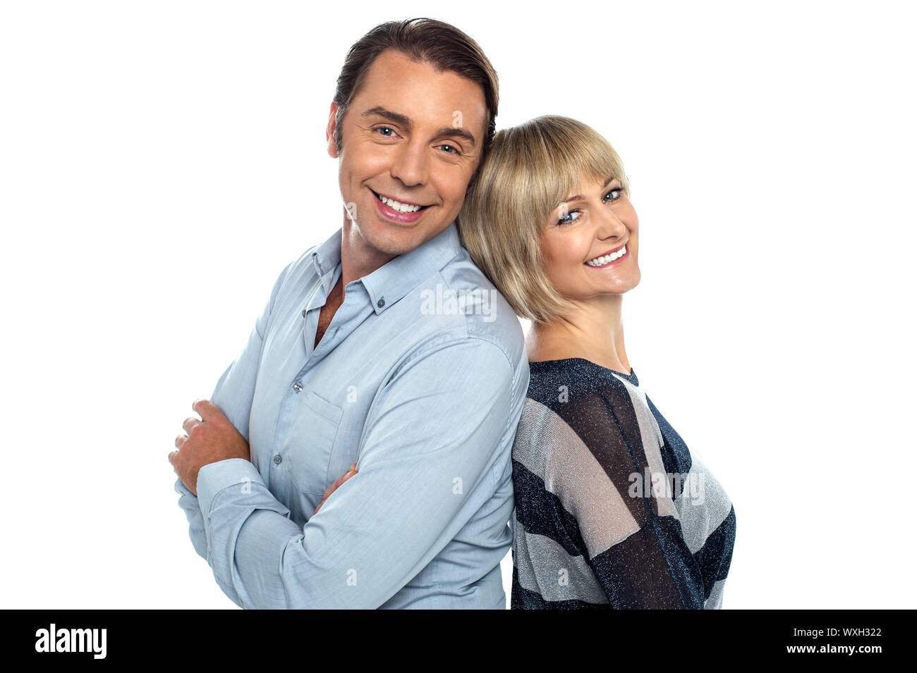Isolated couple leaning against each other Stock Photo - Alamy