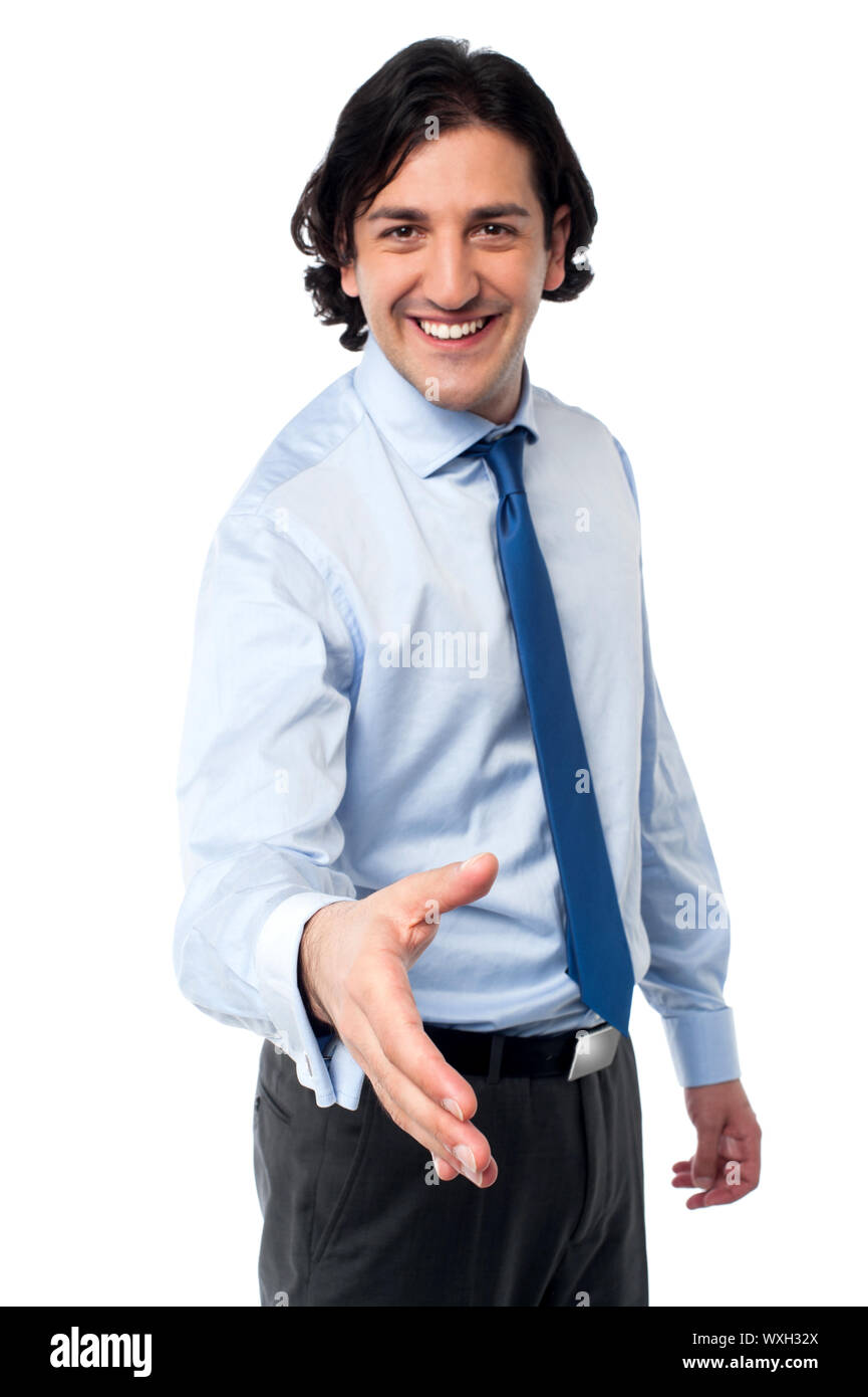 Young businessman holds out his hand for a handshake Stock Photo - Alamy