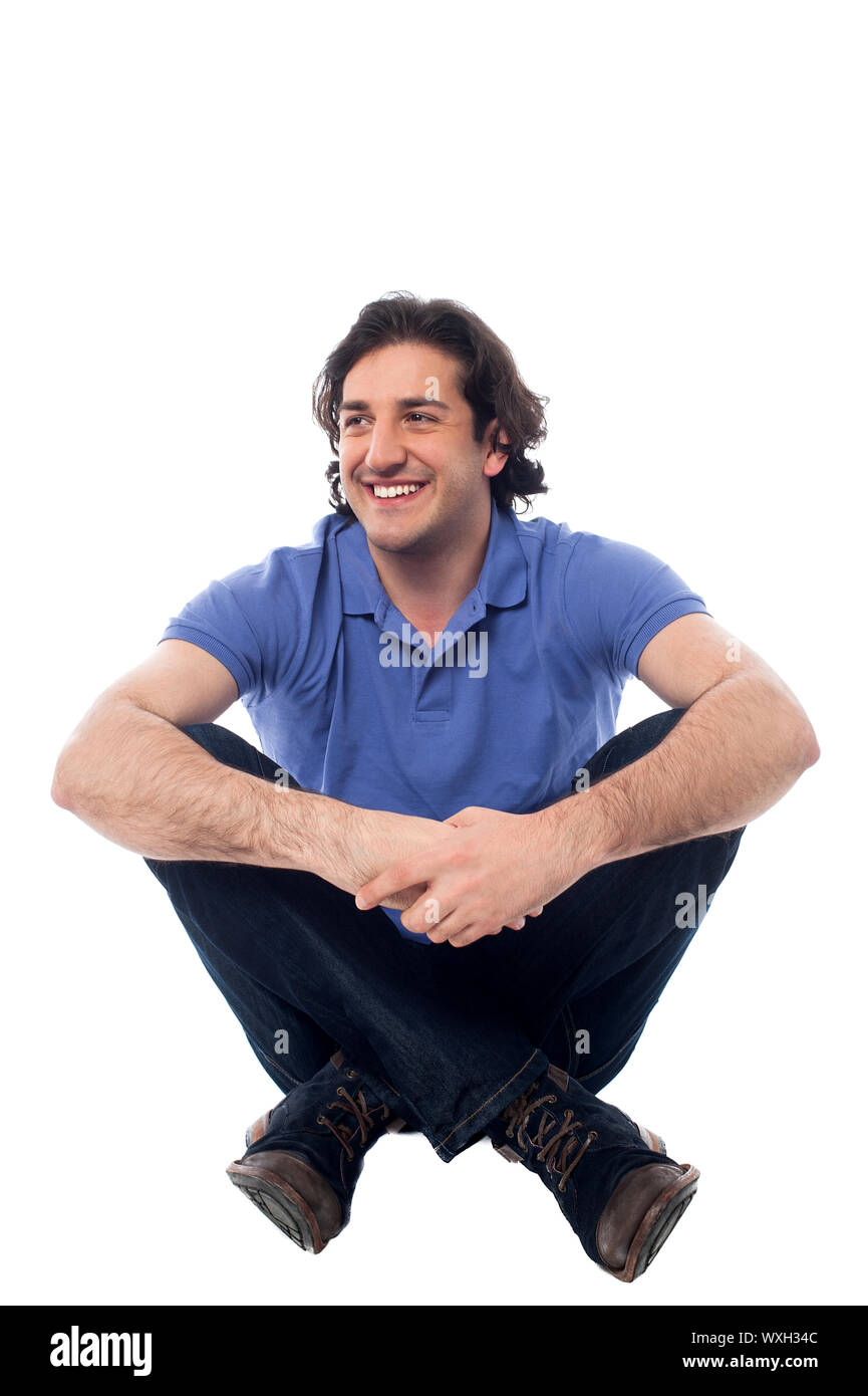 Young smart guy sitting on the floor Stock Photo - Alamy